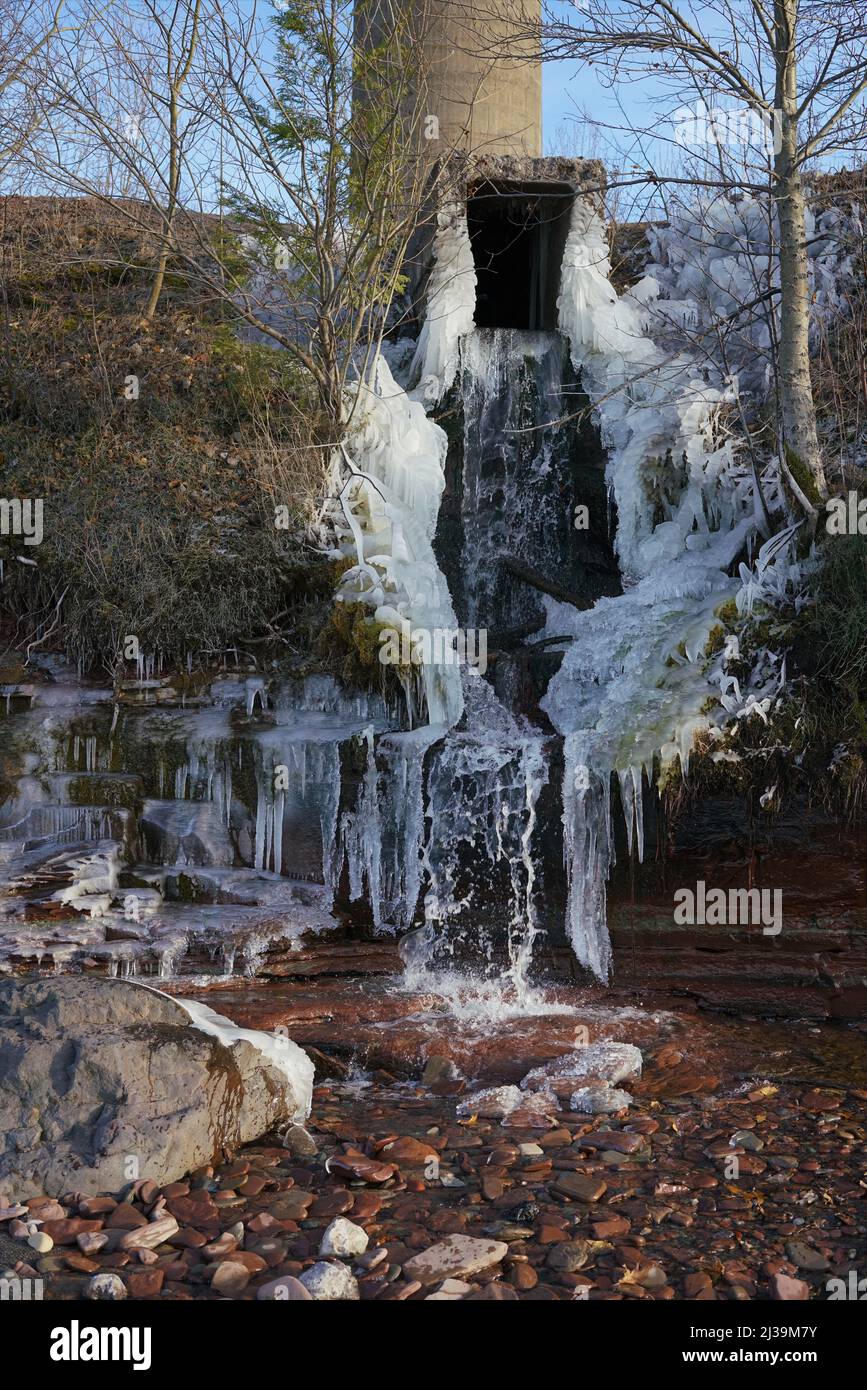 A vertical shot of Old Mining Ruins and a frozen waterfall Stock Photo ...