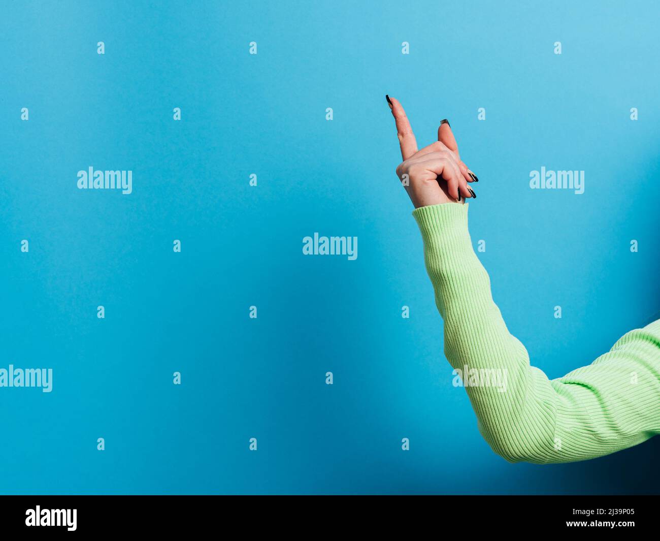 Woman's hand pointing up to to something over an isolated background ...