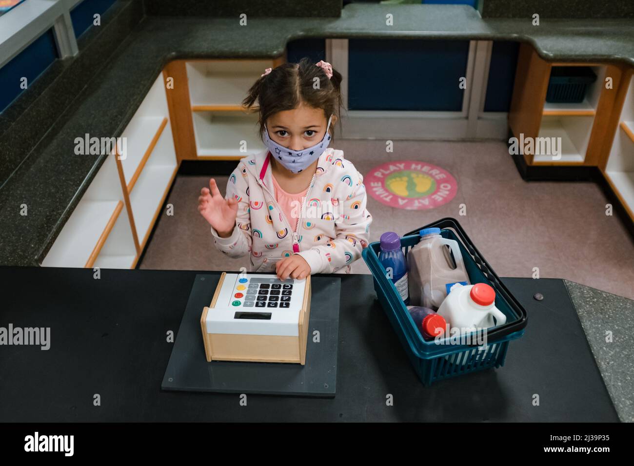 young girl playing with cash register Stock Photo - Alamy