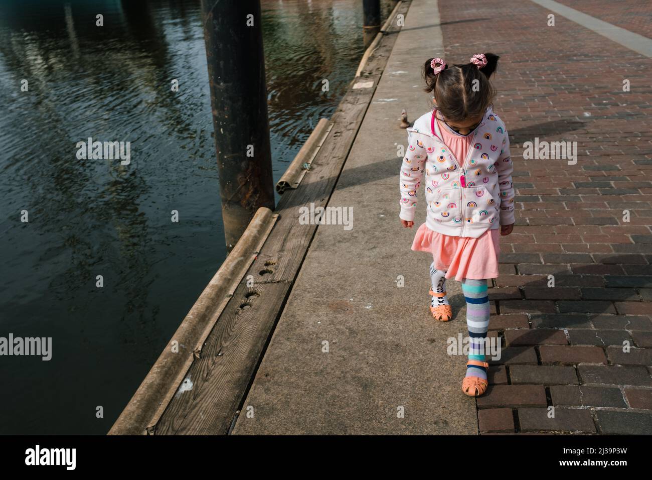 young girl walking outside near water Stock Photo - Alamy