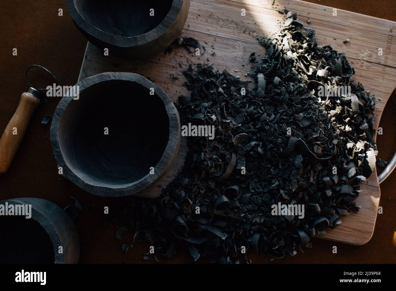 Clay pottery bowls in shadow on wood cutting board Stock Photo - Alamy