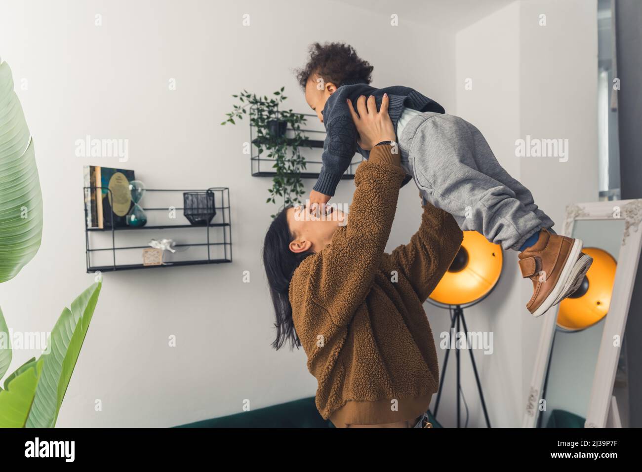Mother lifting up her child hi-res stock photography and images - Alamy