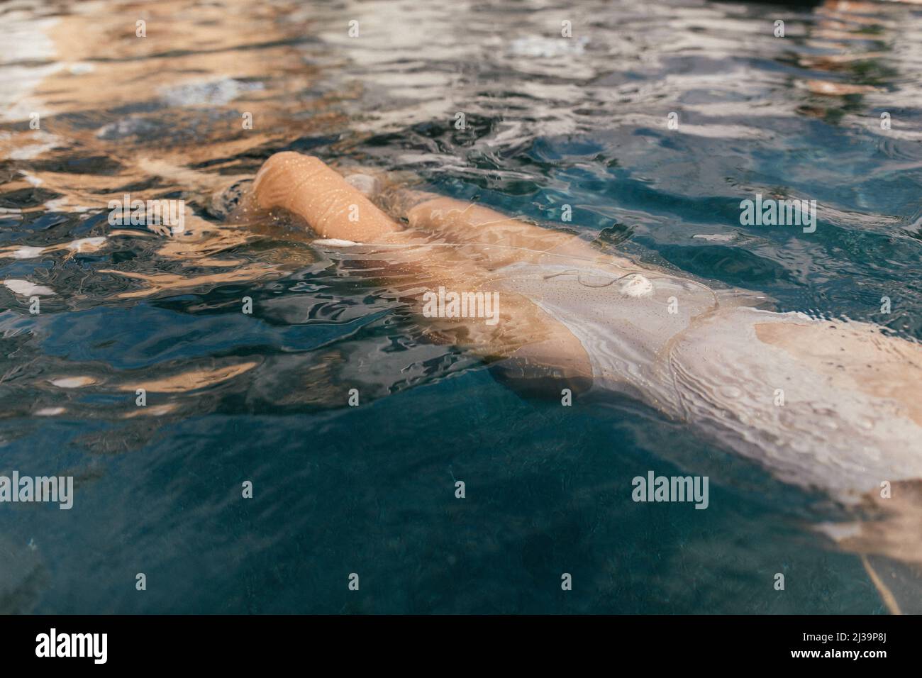 Woman floating on back in hi-res stock photography and images - Alamy