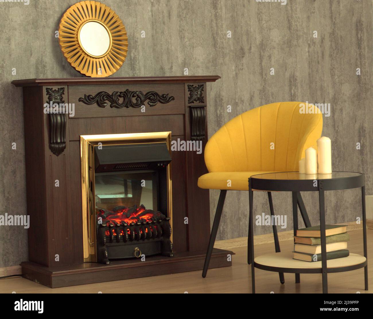Classic interior design with yellow armchair and fire in fireplace ...