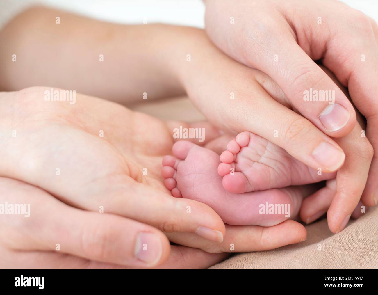 New Family with Newborn Feet Stock Photo - Alamy