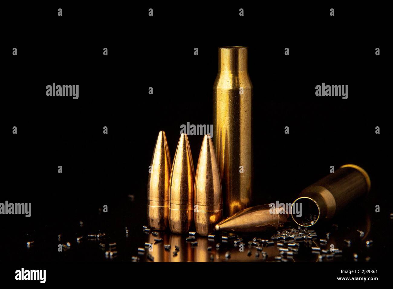 Bullet isolated on black background with reflexion. Rifle bullets close ...