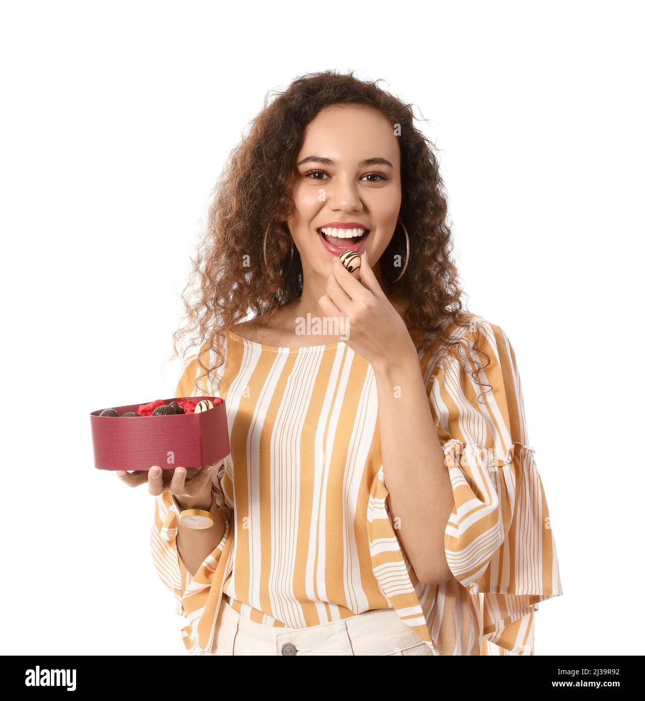 Beautiful young woman with delicious chocolate candies in box on white ...