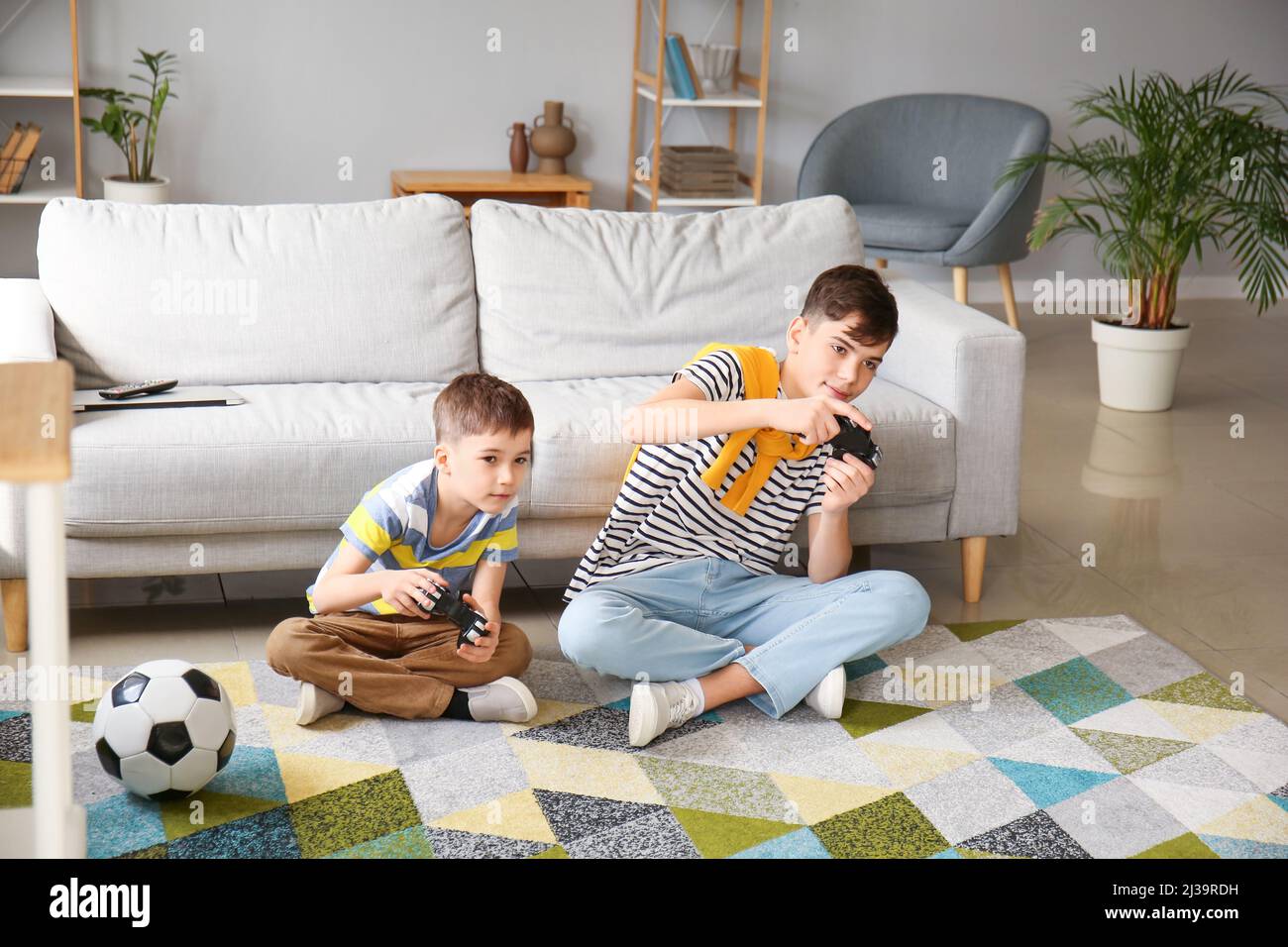 Cute brothers playing video game at home Stock Photo - Alamy