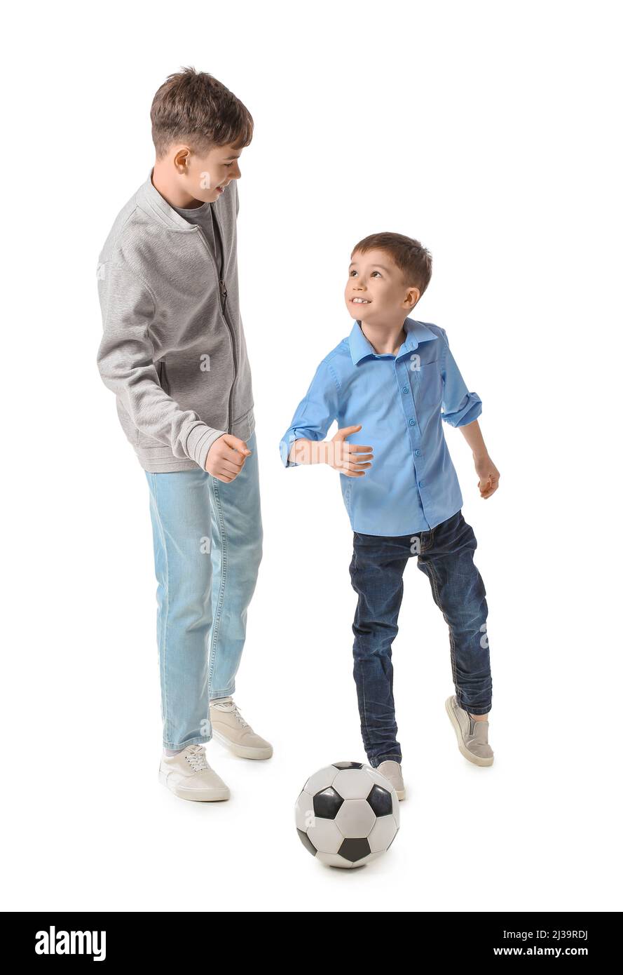 Cute brothers playing with soccer ball on white background Stock Photo ...