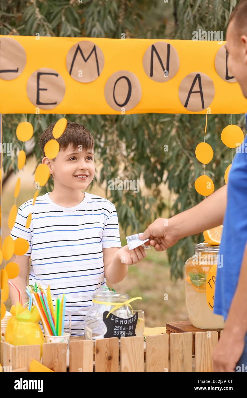 Cute boy selling lemonade in park Stock Photo - Alamy