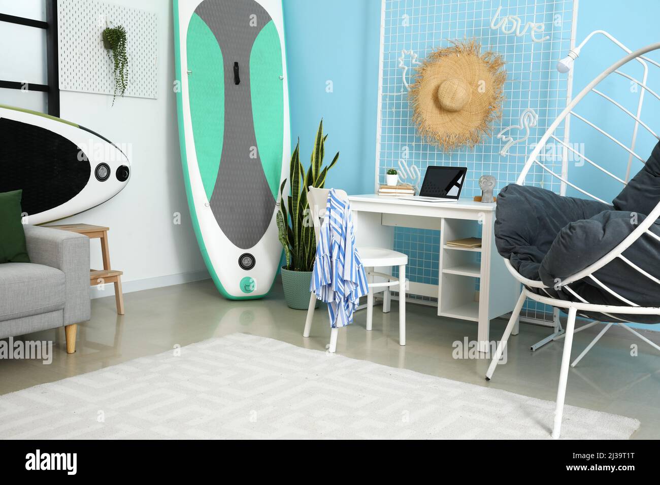 Interior of stylish room with comfortable workplace and board for sup ...