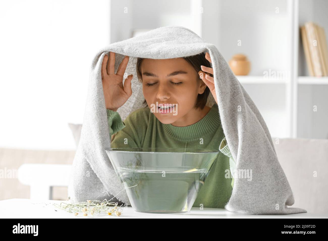 Young woman doing steam inhalation at home to soothe and open nasal ...