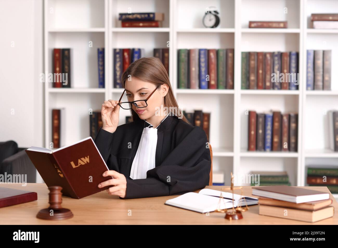 Female judge with book at workplace in courtroom Stock Photo - Alamy