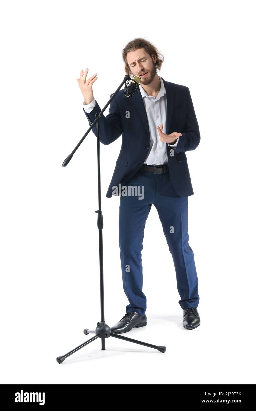 Handsome young man singing in microphone isolated on white Stock Photo ...