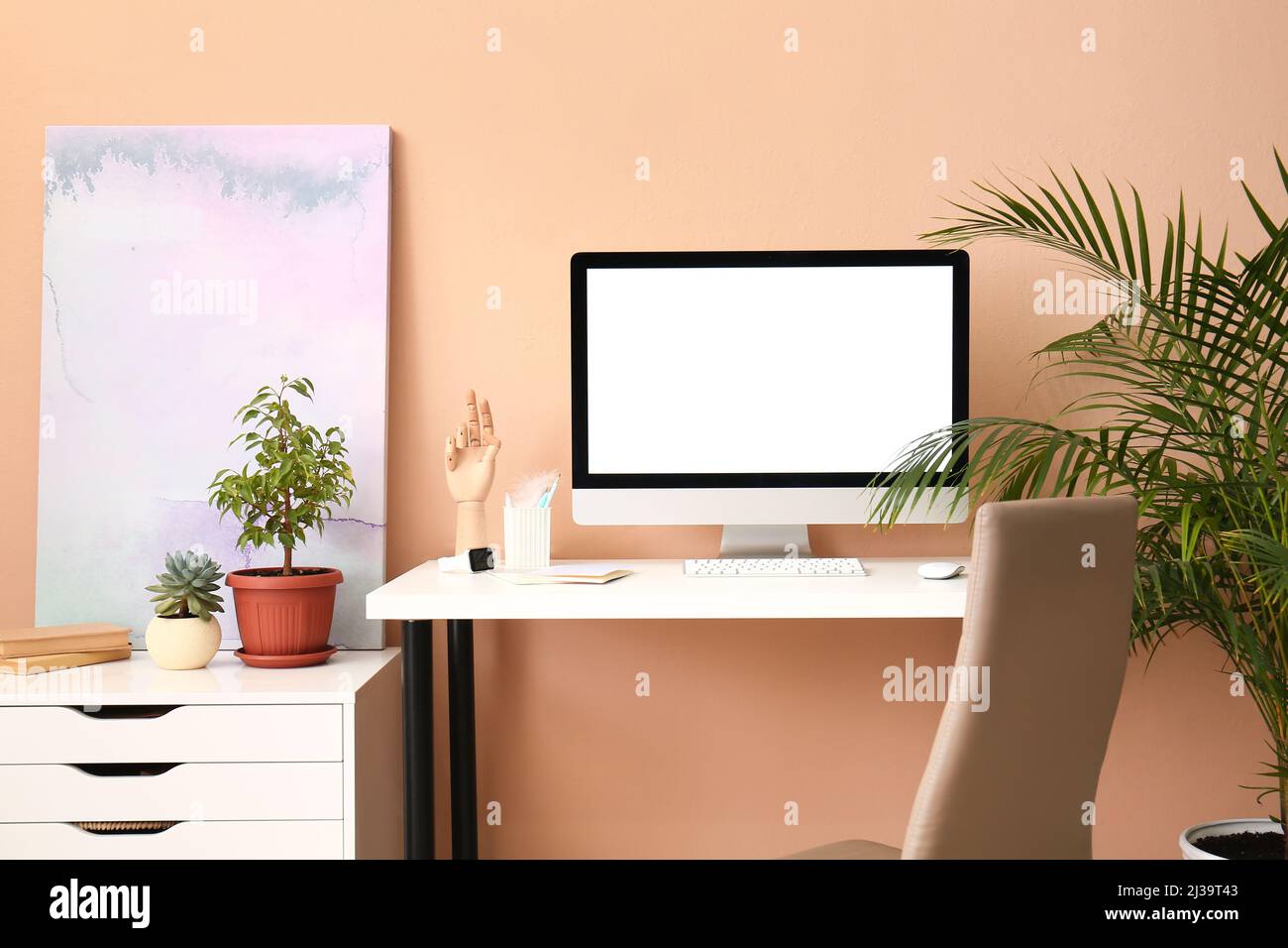 Workplace with modern computer near color wall Stock Photo - Alamy