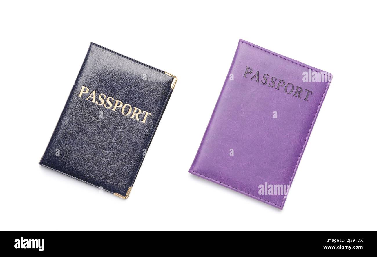 Different passports on white background Stock Photo - Alamy
