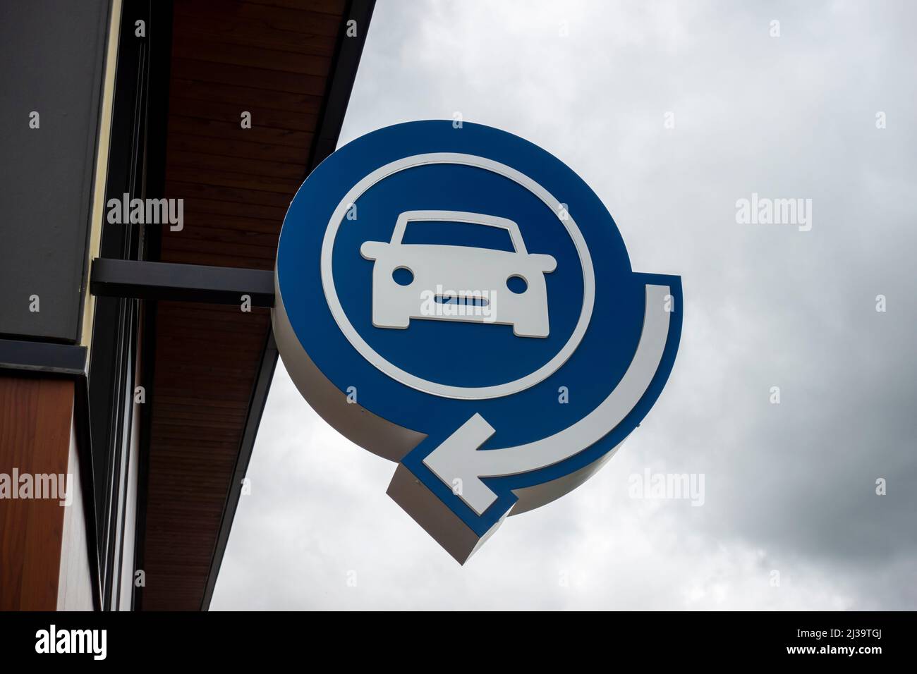 Low angle view of a blue car symbol, indicating a parking garage ...