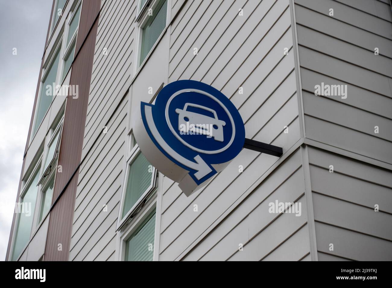 Low angle view of a blue car symbol, indicating a parking garage ...