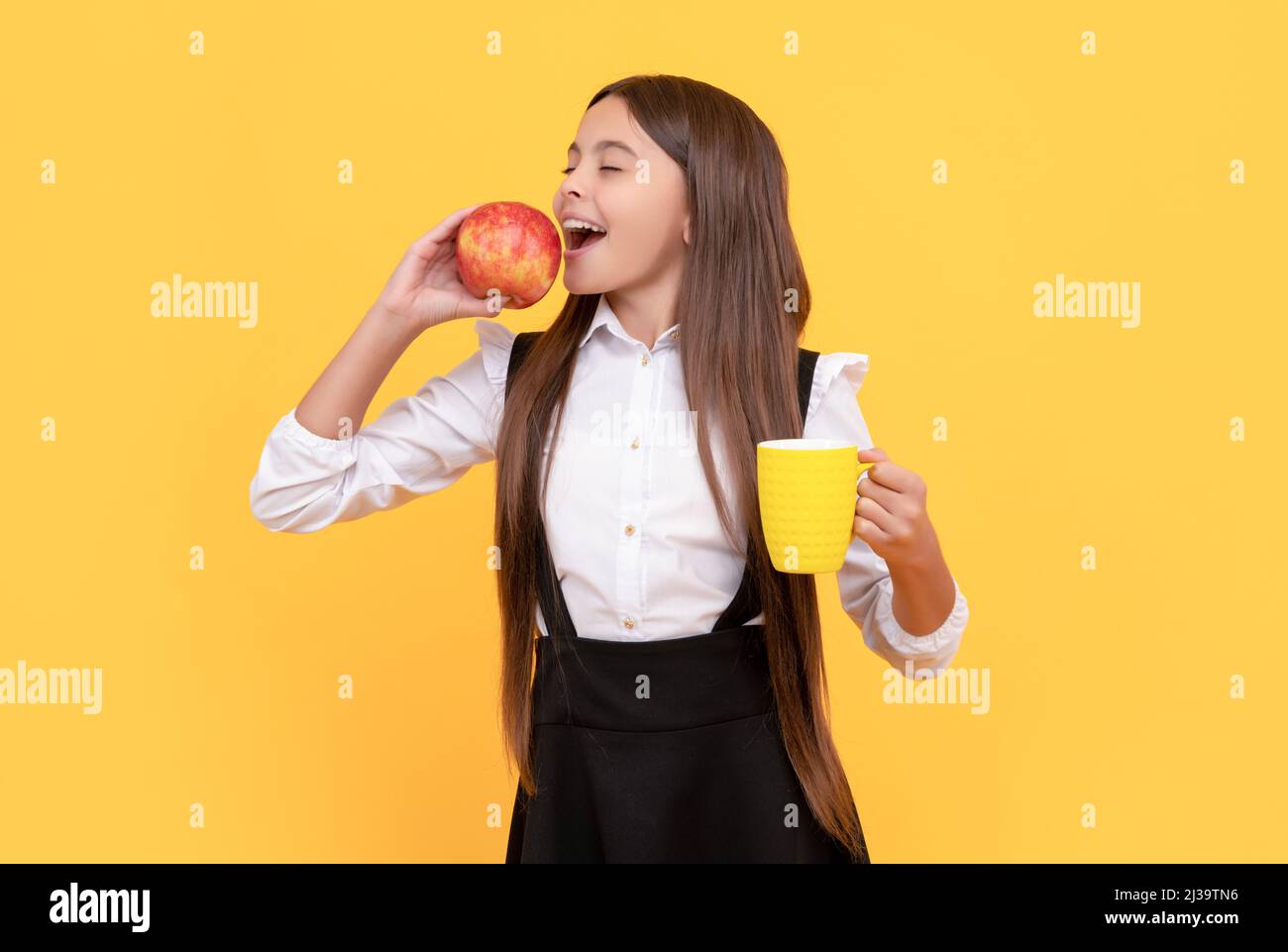 smiling kid keep water balance in body. teen girl with apple fruit and ...