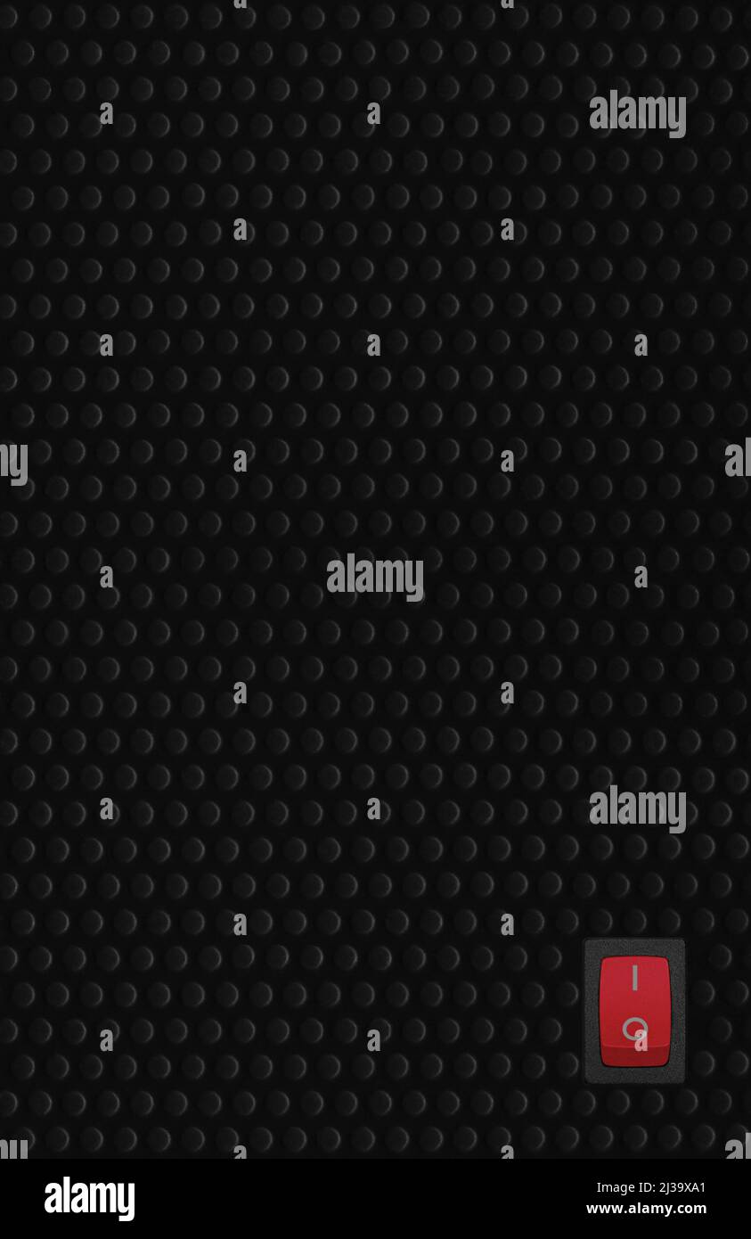 Red rectangle rocker power switch in on position, black abstract dot ...