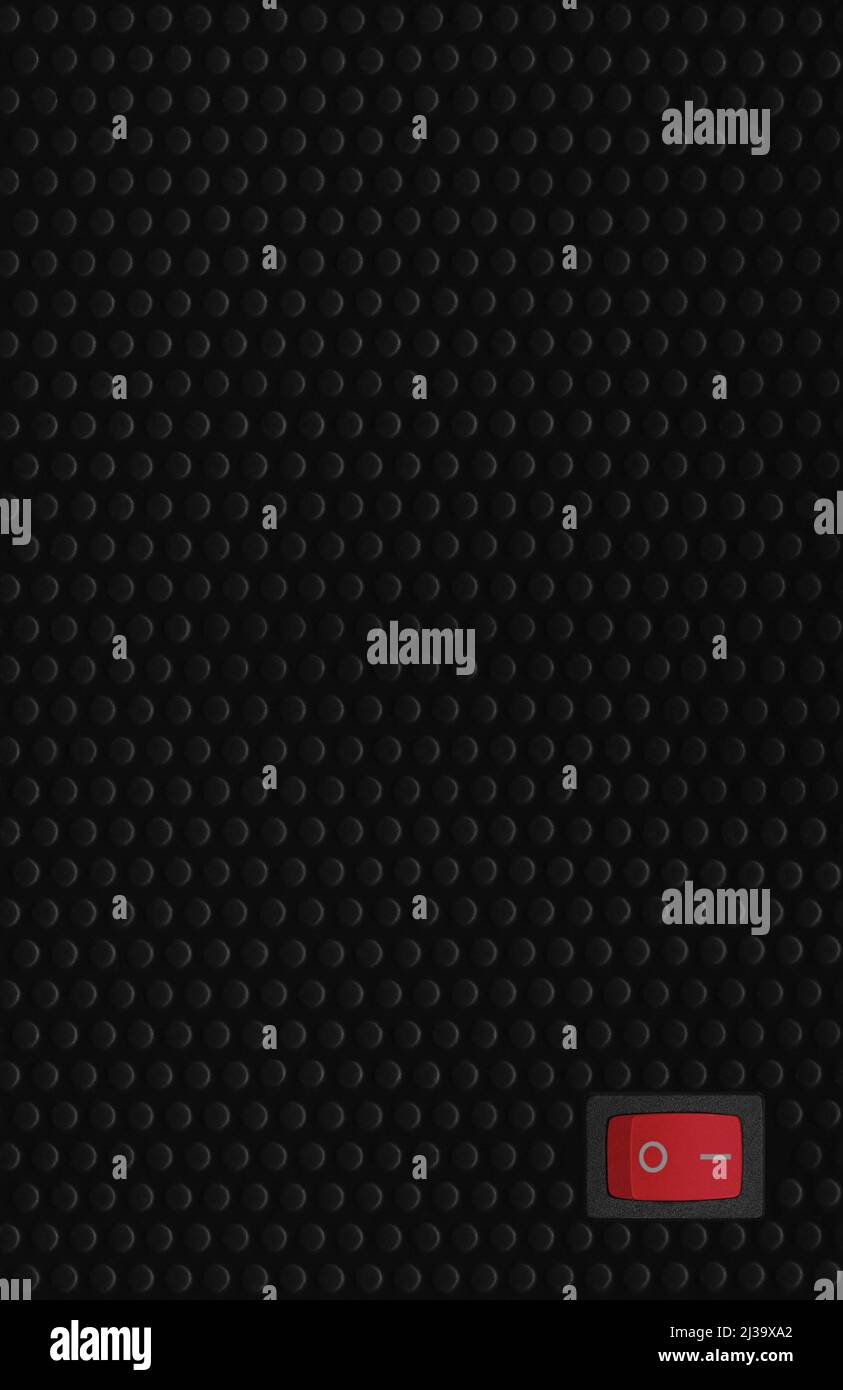 Red rectangle rocker power switch in on position, black abstract dot ...