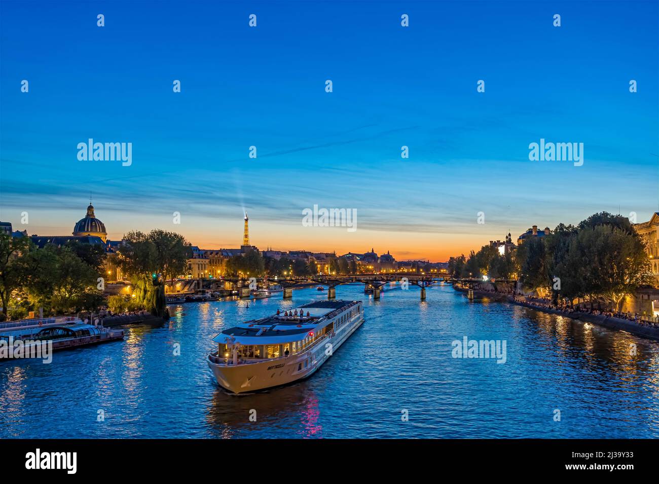 Huge Boats Cruises Over Seine River in Paris at Twilight Sunset With Eiffel Tower Stock Photo ...