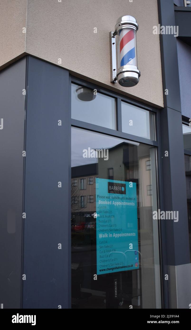 Traditional white, red and blue barber's pole Stock Photo - Alamy