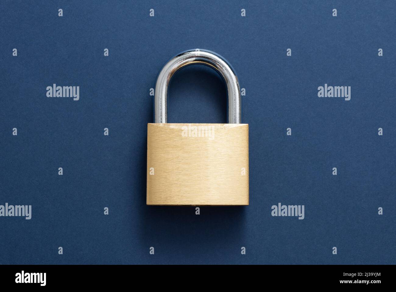 Golden Locked Padlock on the blue background Stock Photo - Alamy