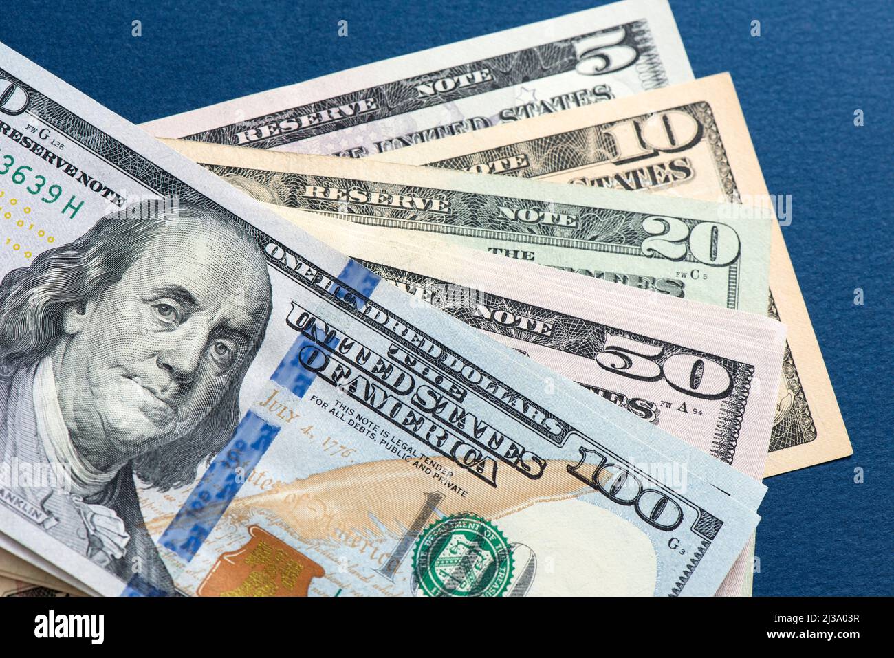 Many american dollar banknotes corner on the blue background Stock ...