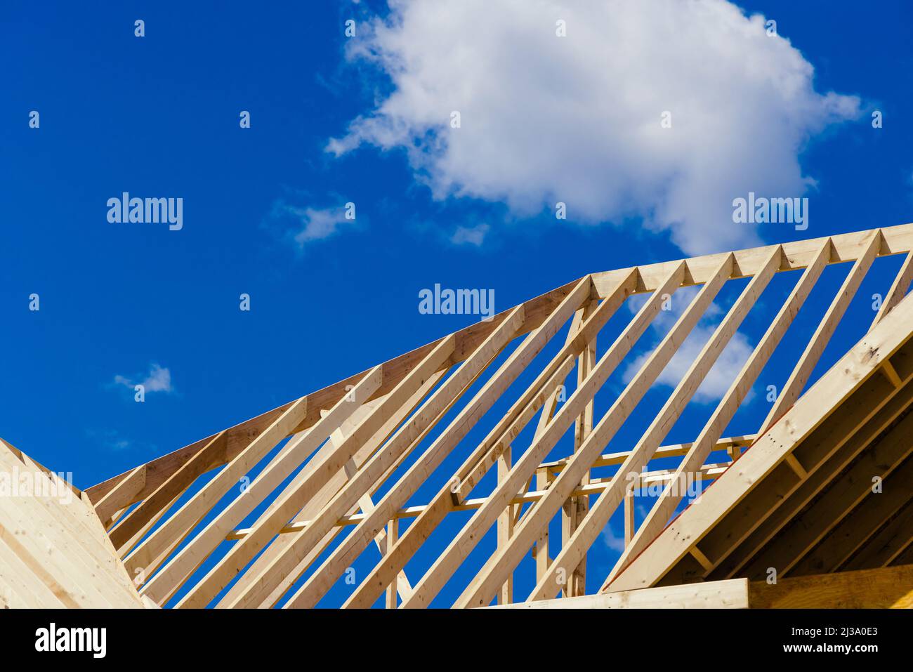 Framework of beam framing unfinished roofing for new home with wooden ...