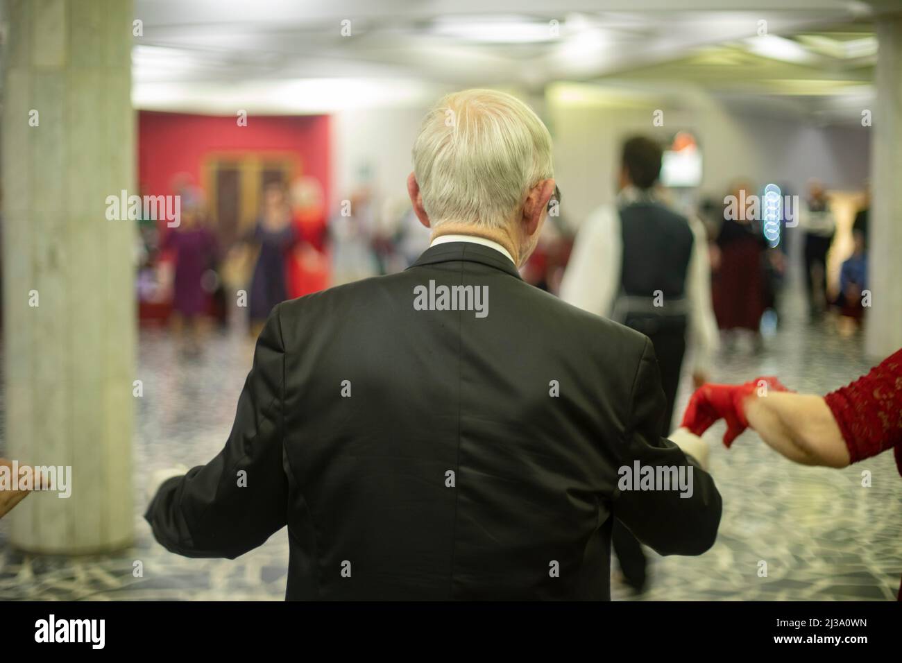 Old man at meeting of graduates. Seniors at event. Dancing friends ...