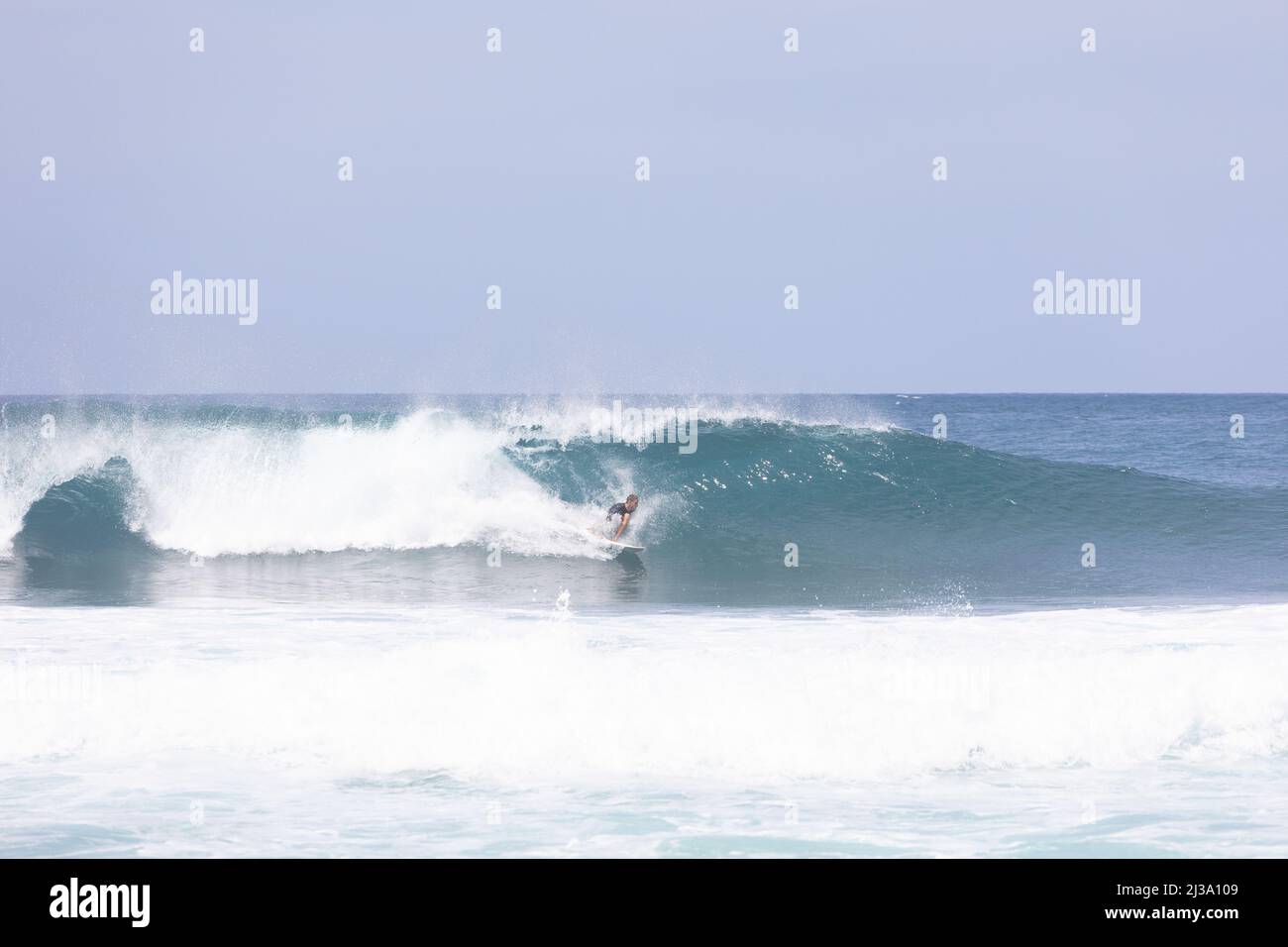 Surfer catching a wave at the Banzai Pipeline in Hawaii Stock Photo - Alamy