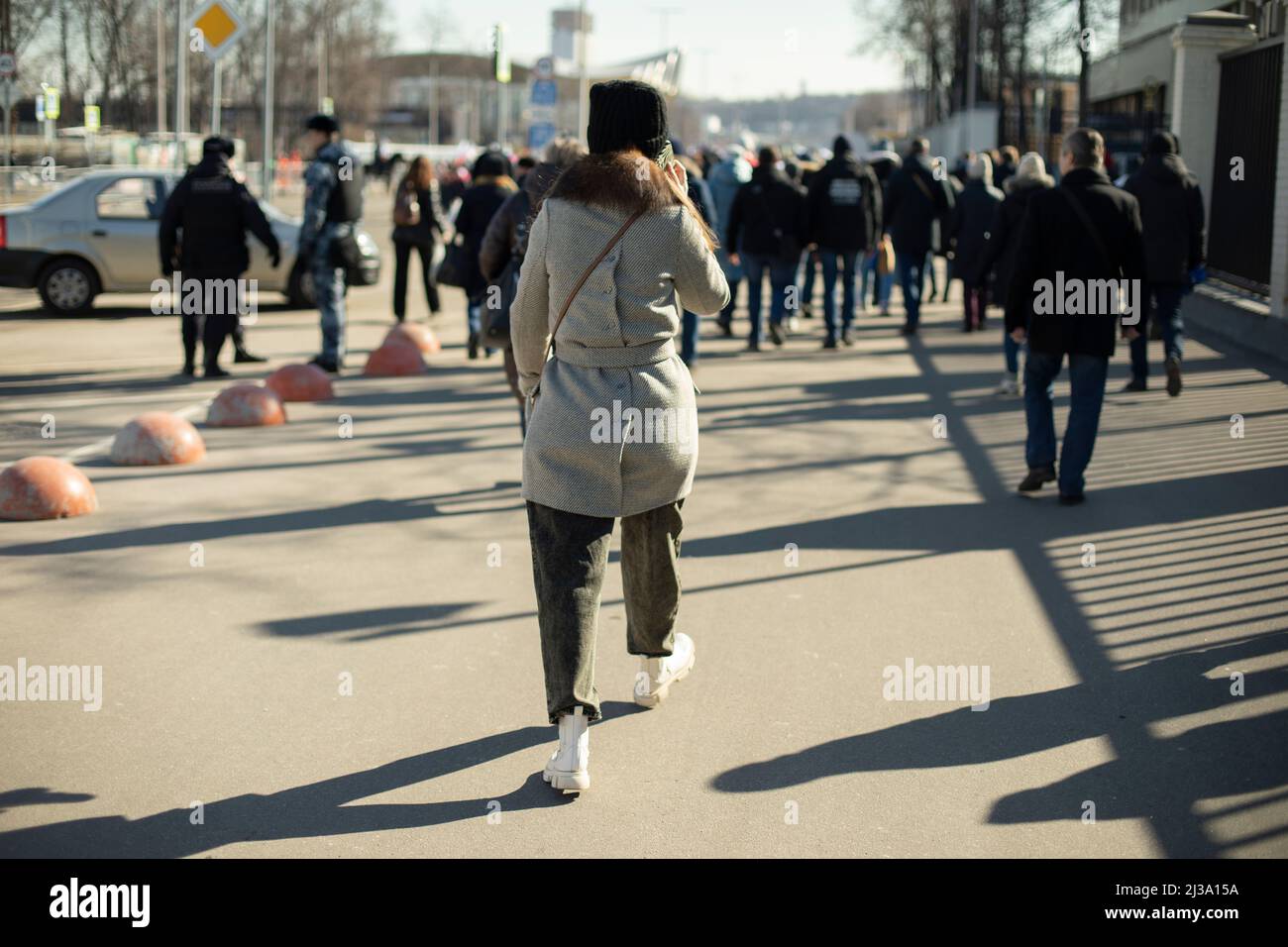 Girl walks through city. Woman on street. Spring clothes on person ...