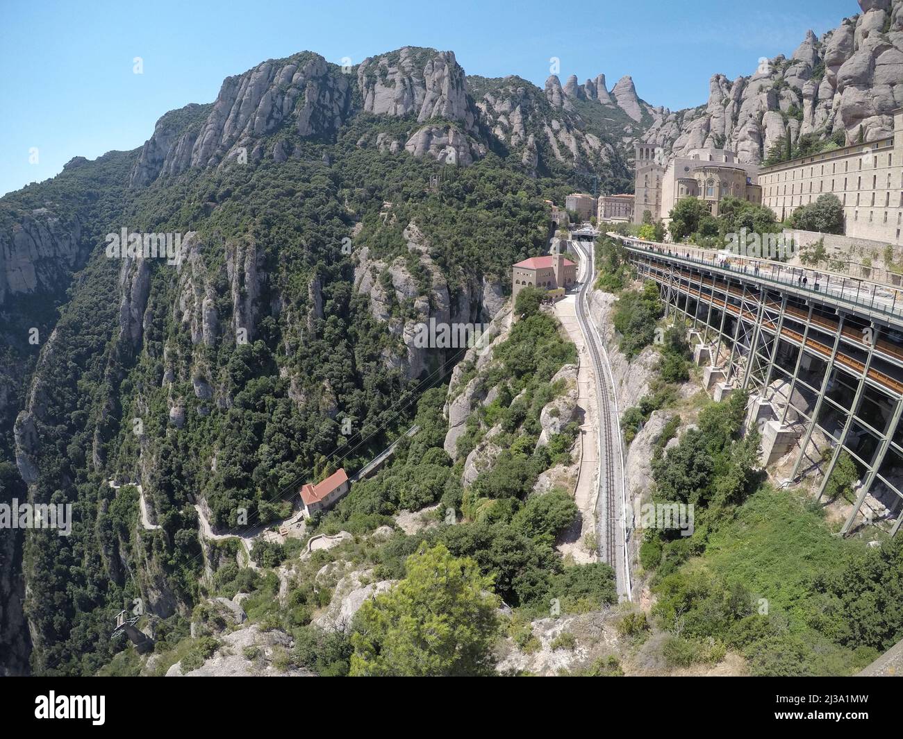 A perspective shot of the buildings in the background of tall cliffs in ...