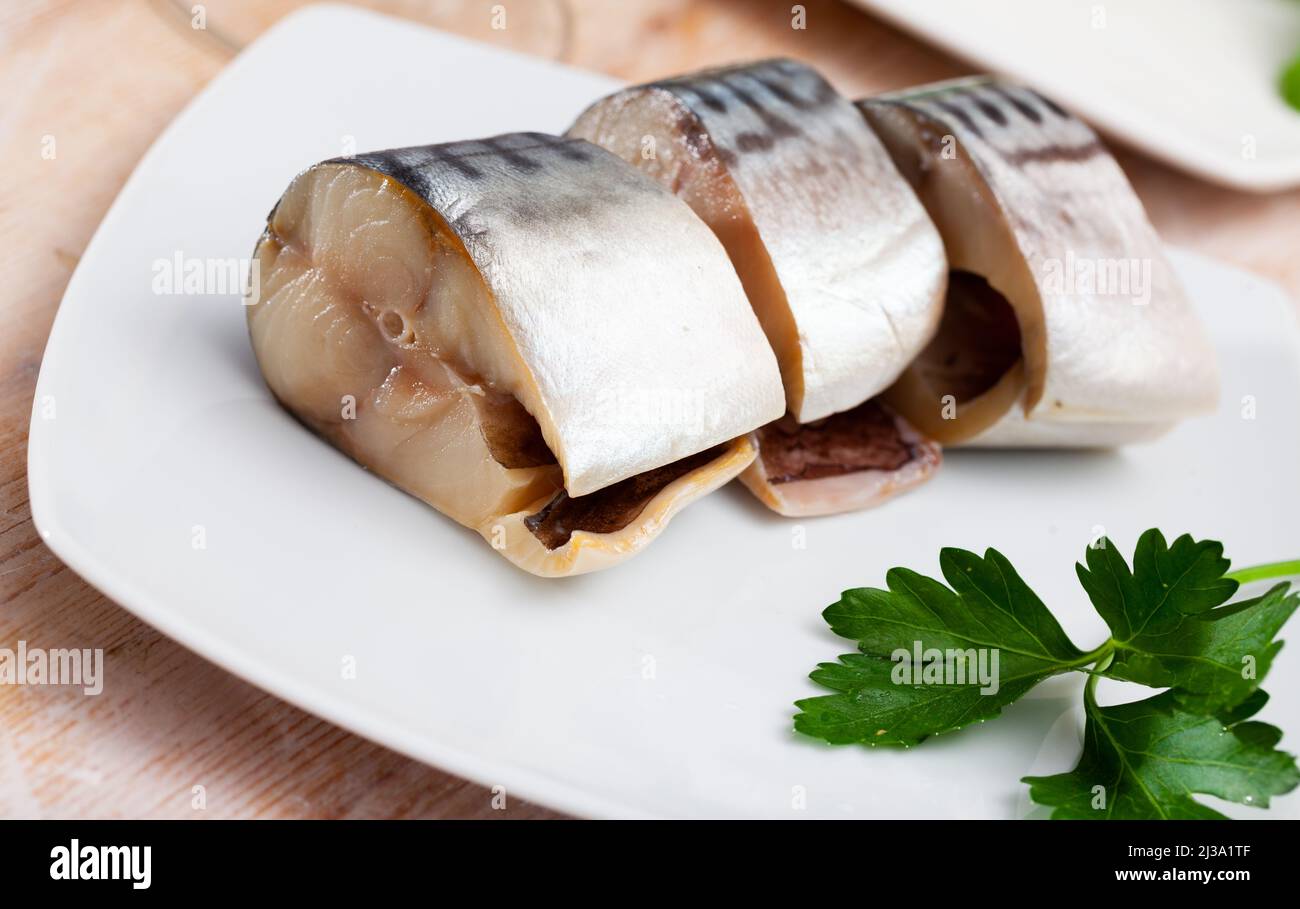 Slices of lightly salted mackerel fish served with greens Stock Photo ...