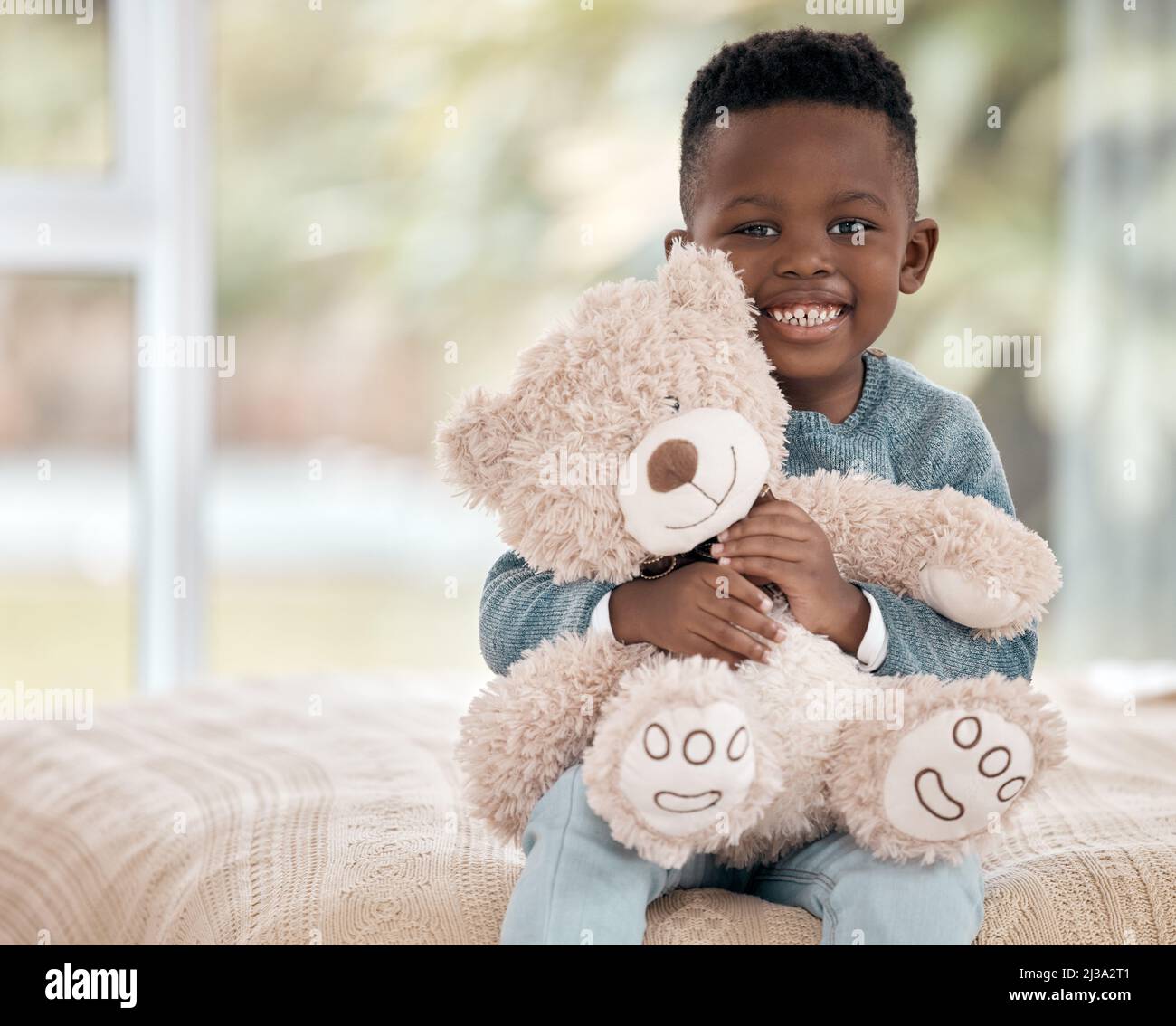 I love my teddy. Cropped portrait of an adorable little boy sitting on ...