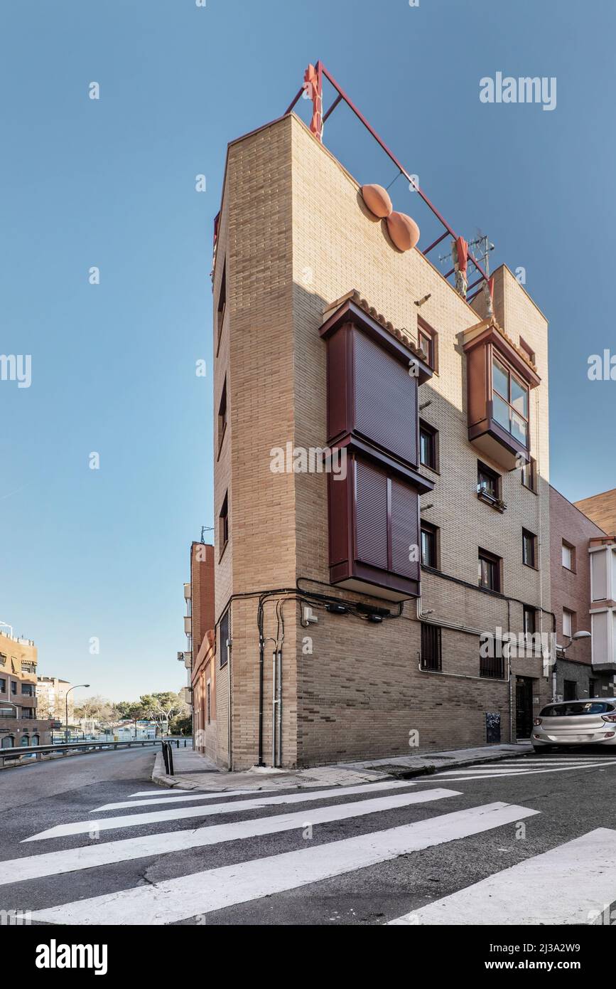 Facade of an urban residential apartment building in front of a zebra ...