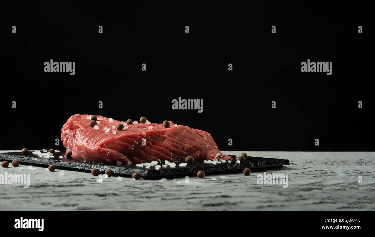 Raw fresh beef steak fillets on a blackboard Stock Photo - Alamy