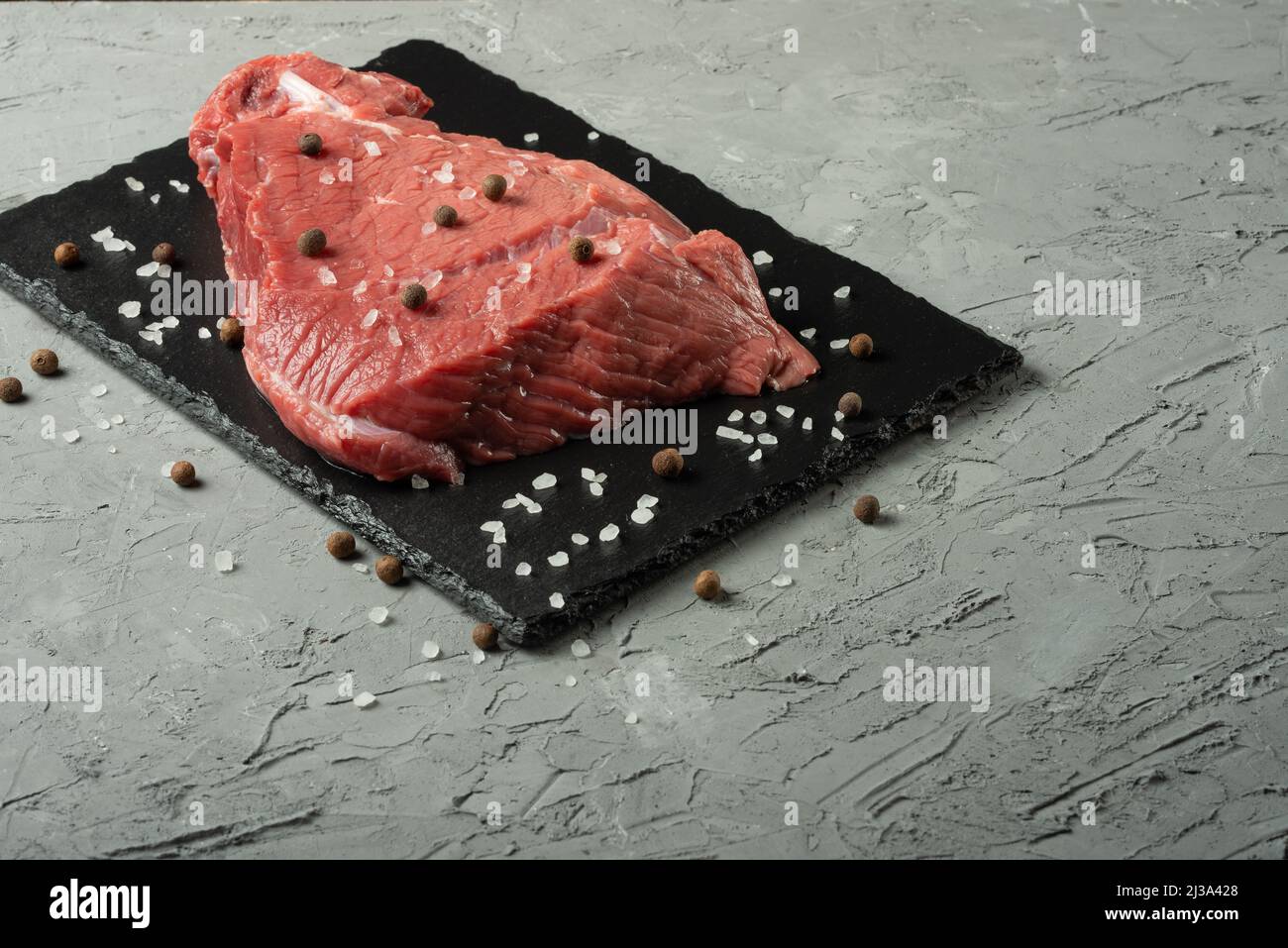 Raw fresh beef steak fillets on a blackboard Stock Photo - Alamy