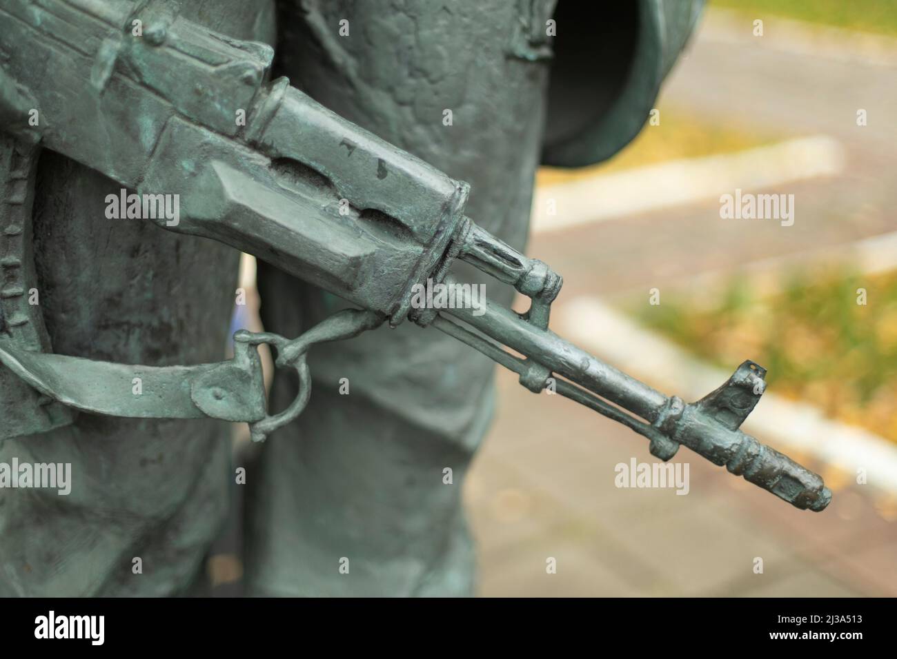 Sculpture of soldier. Machine gun in his hand. War Monument. Firearms ...