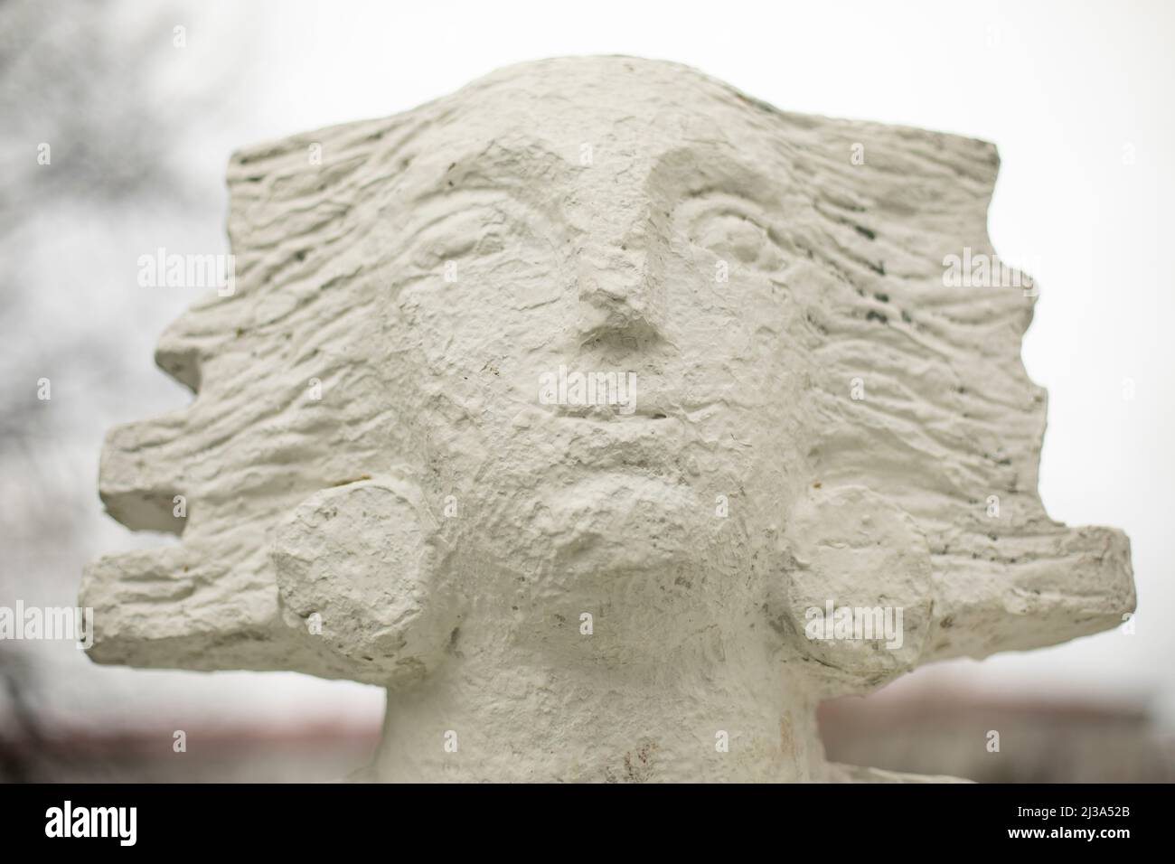 Face of stone. Statue in park. Decoration on street. Sculpture is white ...