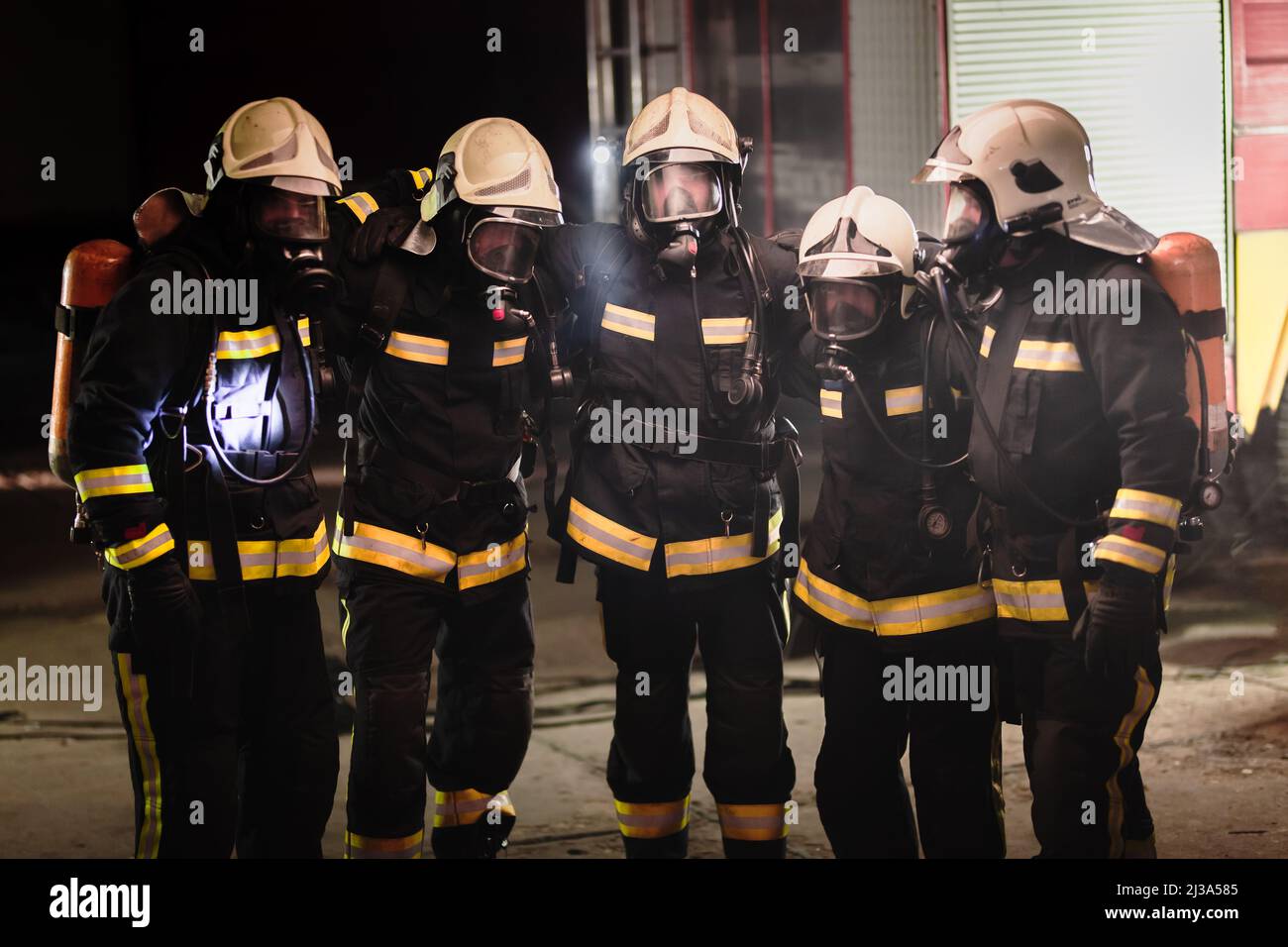 Group of professional firefighters posing. Firemen wearing uniforms ...