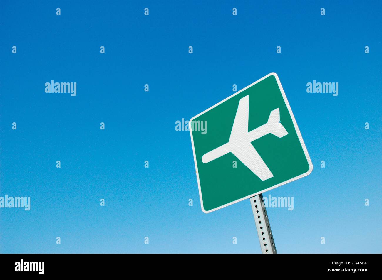 Airport sign with symbol of plane pointing at site for drivers to ...