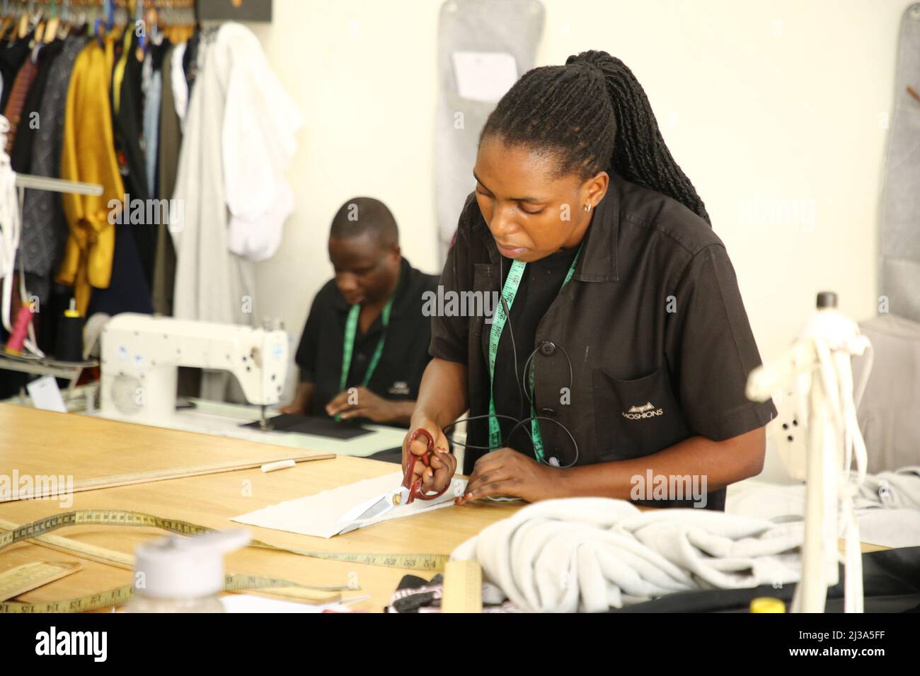 Kigali. 1st Apr, 2022. A staff member makes clothes at upstairs of the ...