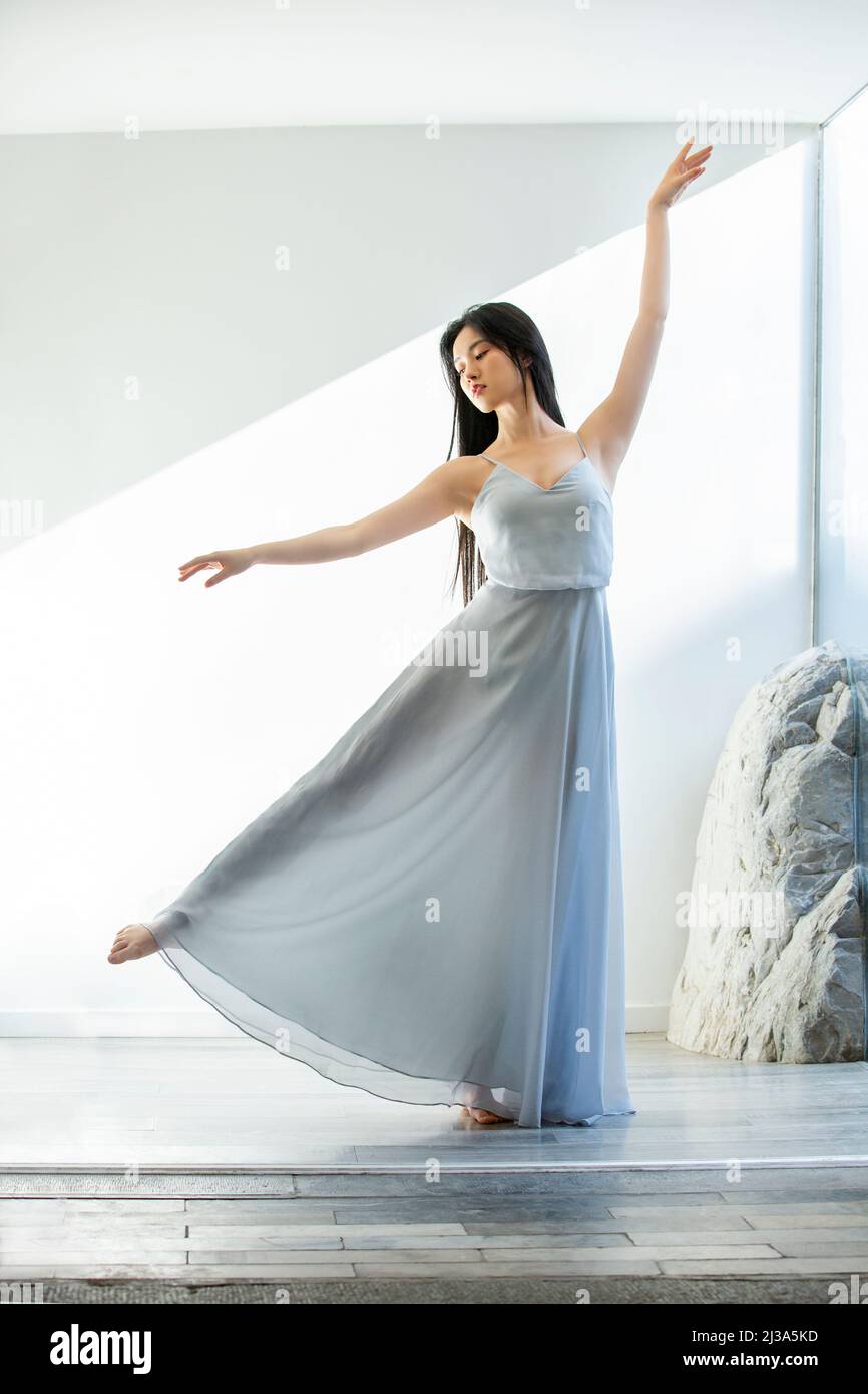 Creative pictures, fashionable female dancer whose train moves with her ...