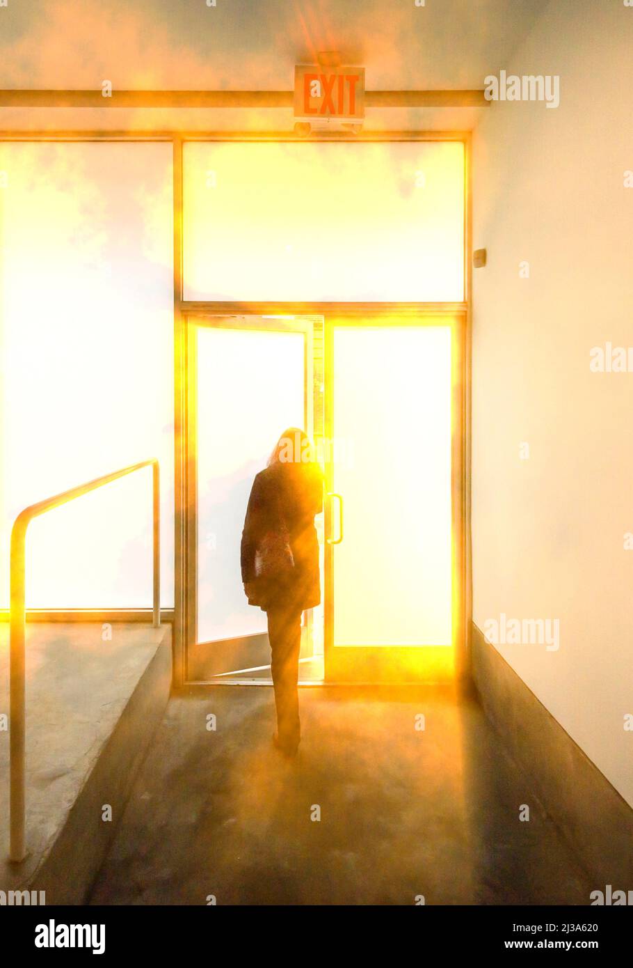 Woman exiting a hallway of a modern office building Stock Photo - Alamy