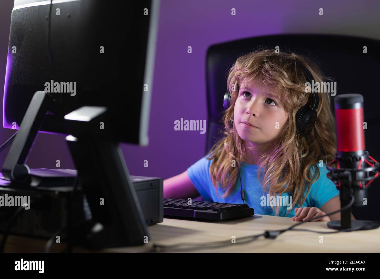 Child learning in virtual online school class. Kid working on laptop ...