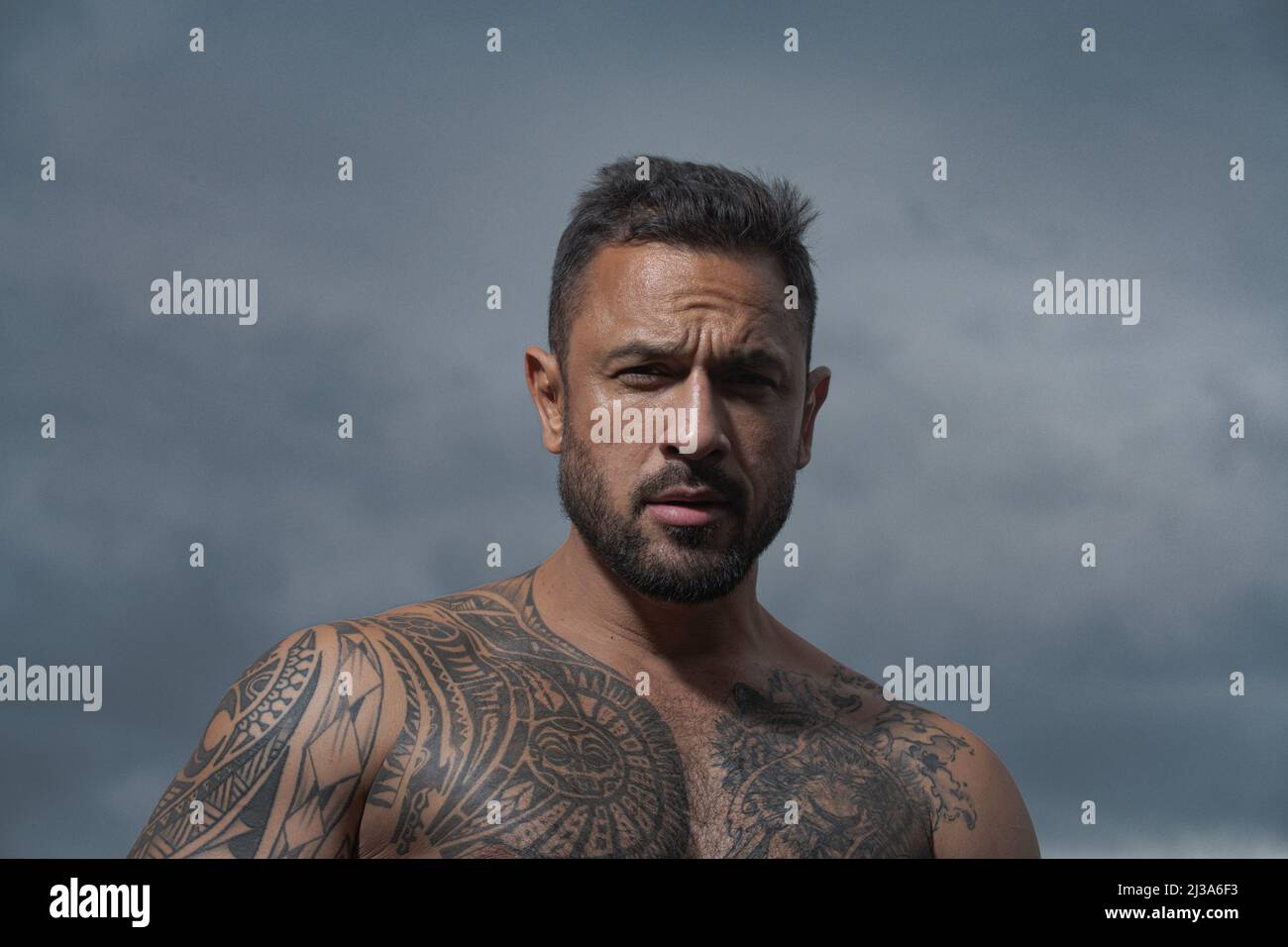 Brutal man, handsome serious male model. Close up portrait of guy with ...