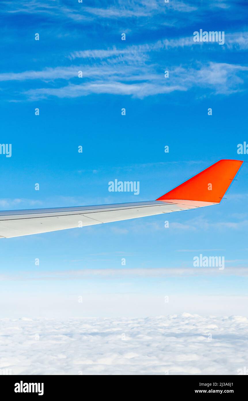 Plane wing, white clouds and blue sky Stock Photo - Alamy
