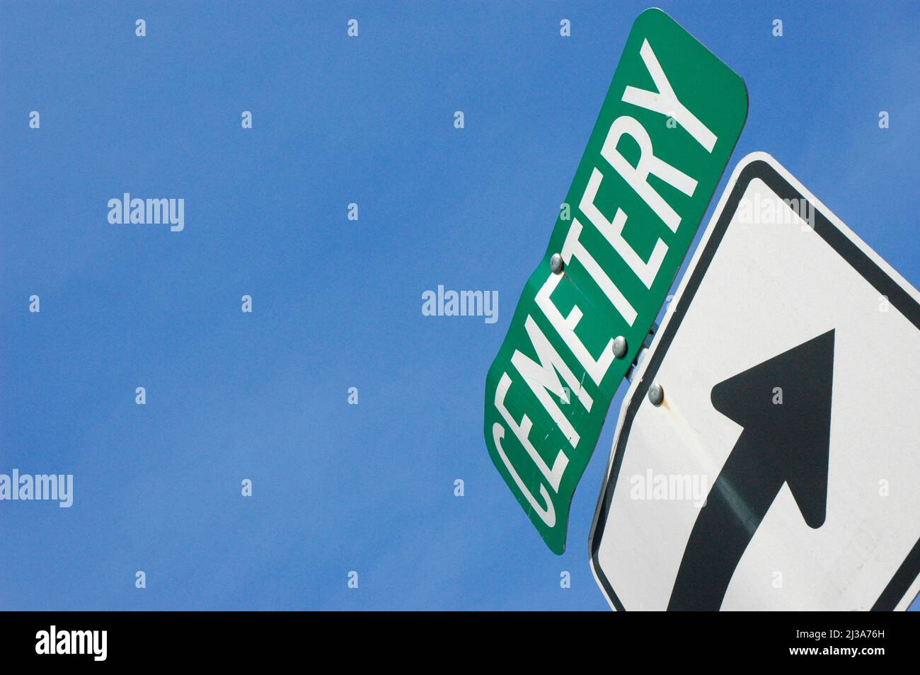 Arrow pointing to cemetery location on roadway Stock Photo - Alamy